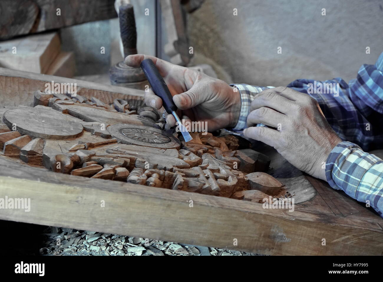 Wood carving. Carver with chisel. A skillful craftsman working on a ...