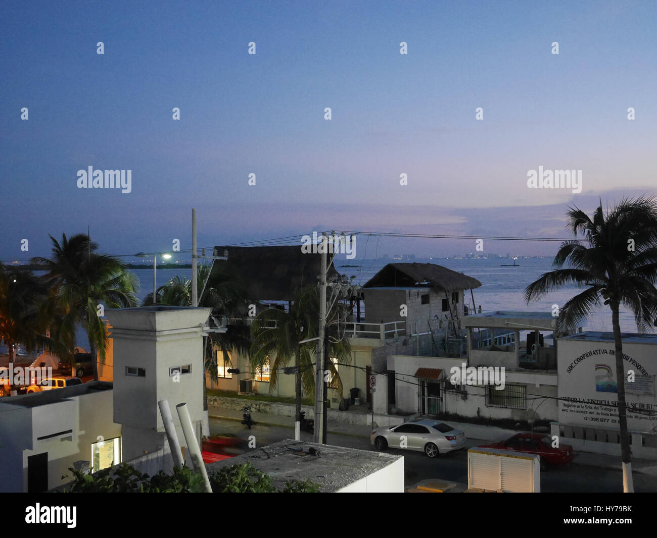 Isla Mujeres in the bright blue night house windows and street lights ...