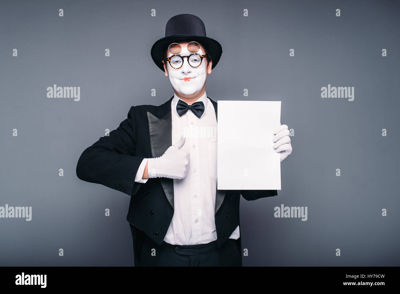 Pantomime actor performing with empty paper sheet. Comedy mime artist ...