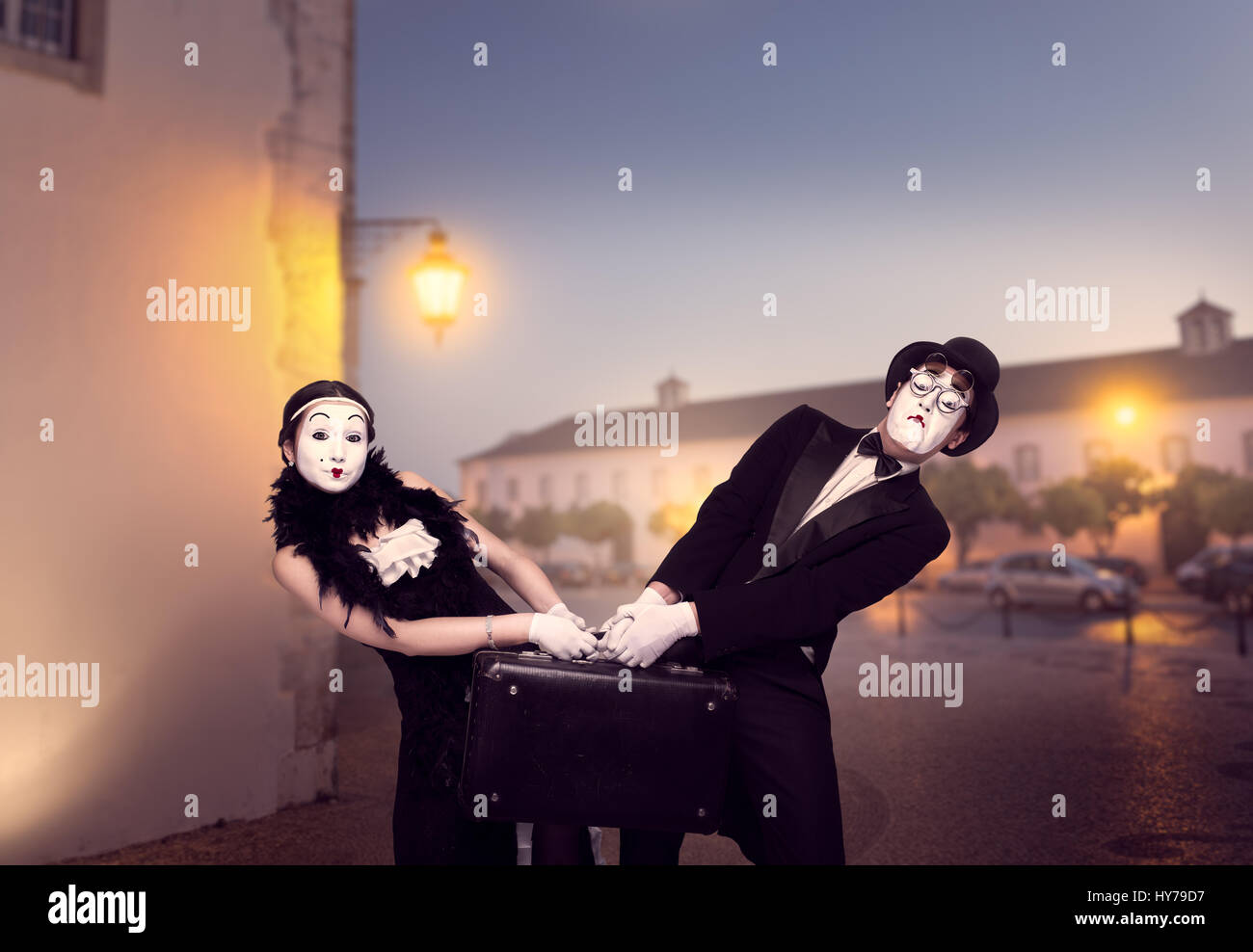 Mime actor and actress performing with suitcase. Pantomime theater ...