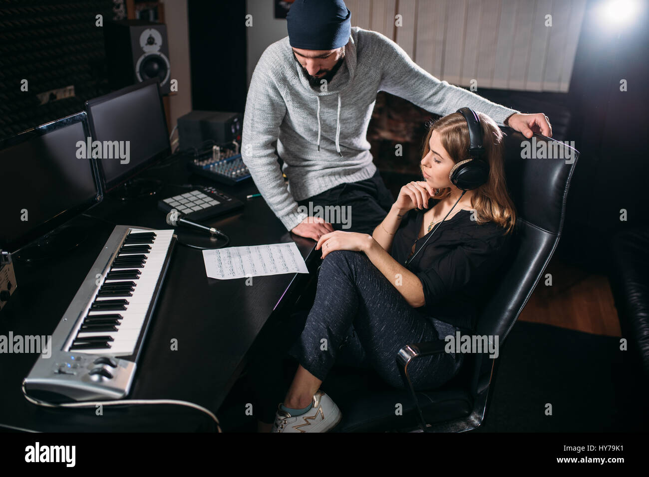 Female singer in headphones listen to song record against sound ...