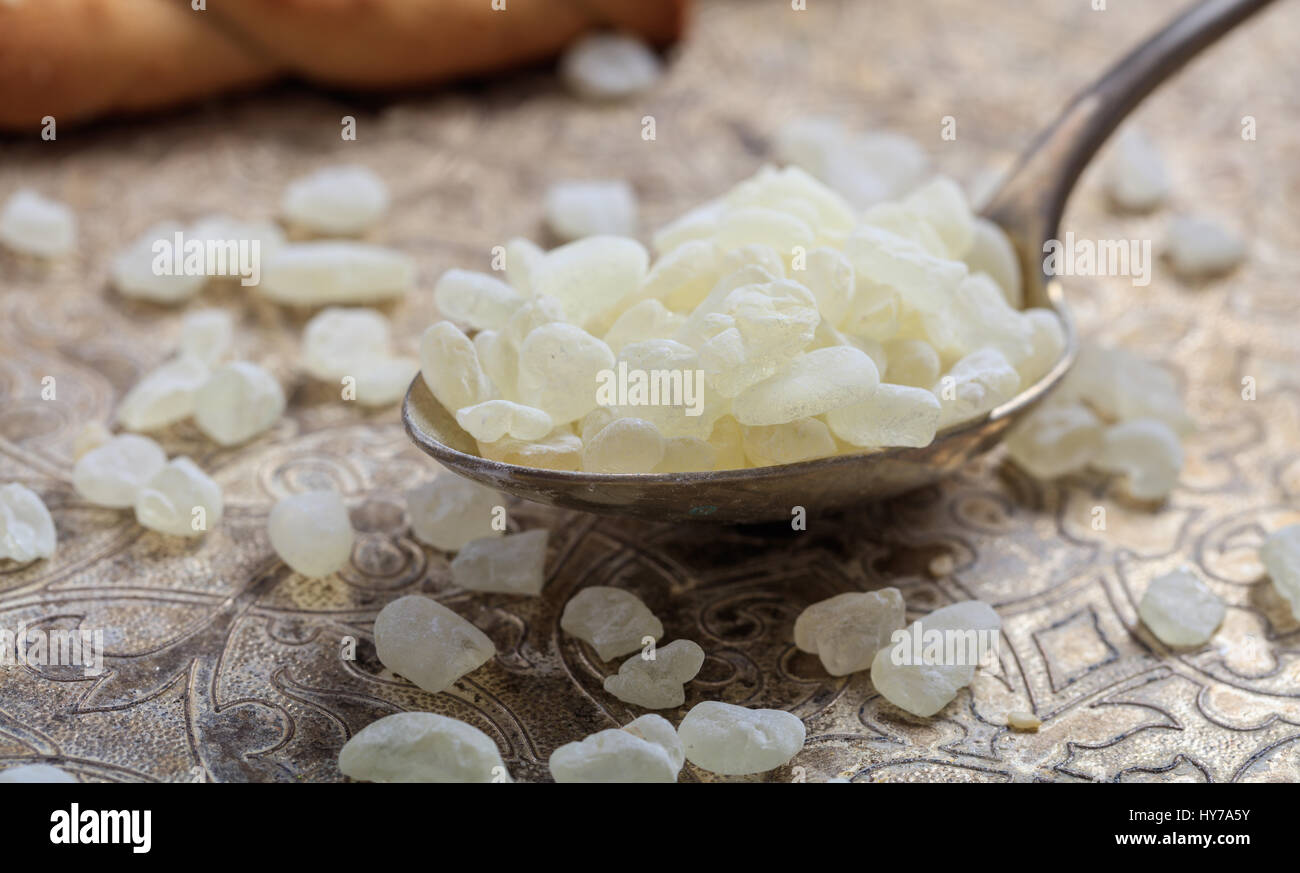 Chios mastic tears in a spoon on a silver background Stock Photo - Alamy