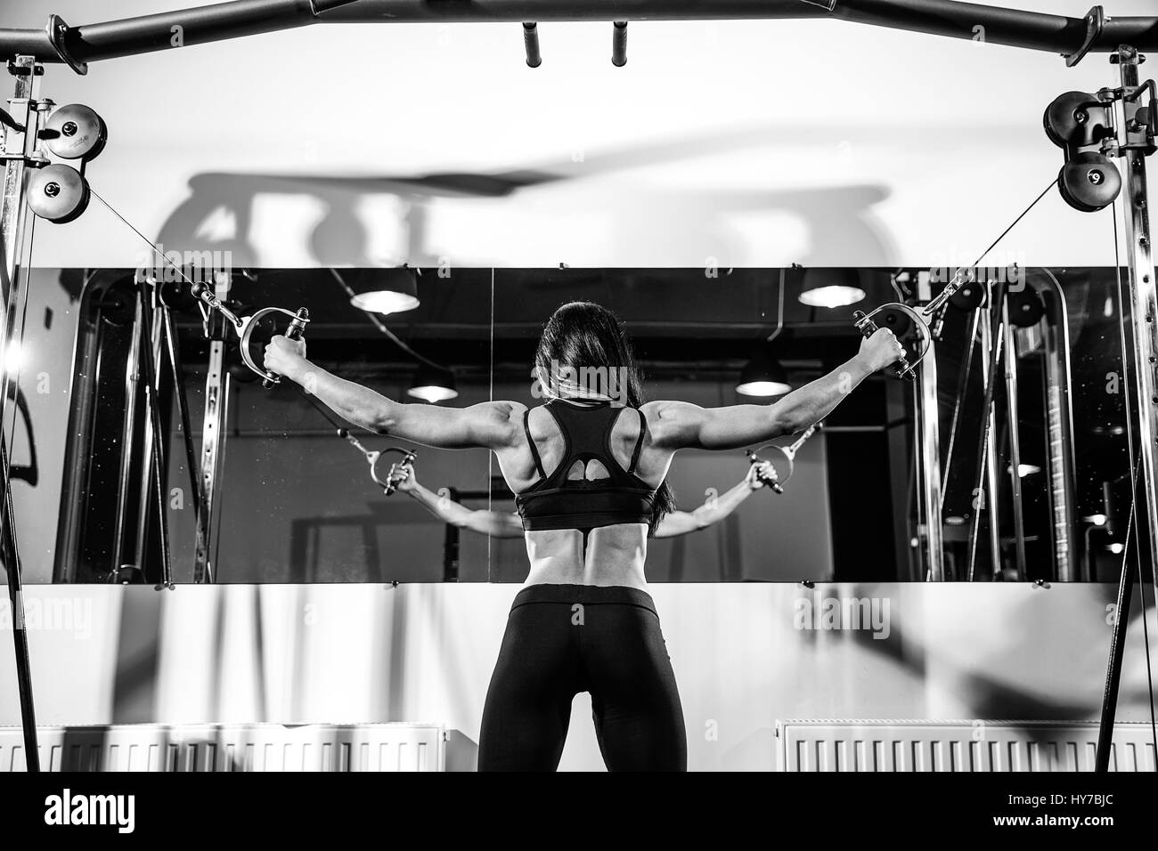 Rear view muscular woman flexing hi-res stock photography and images ...