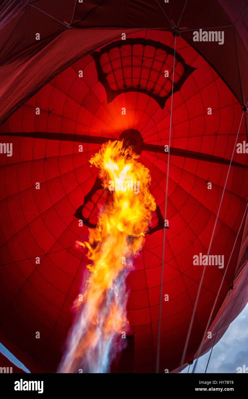 Fire inside a red air balloon heart form rises up at dawn Stock Photo ...