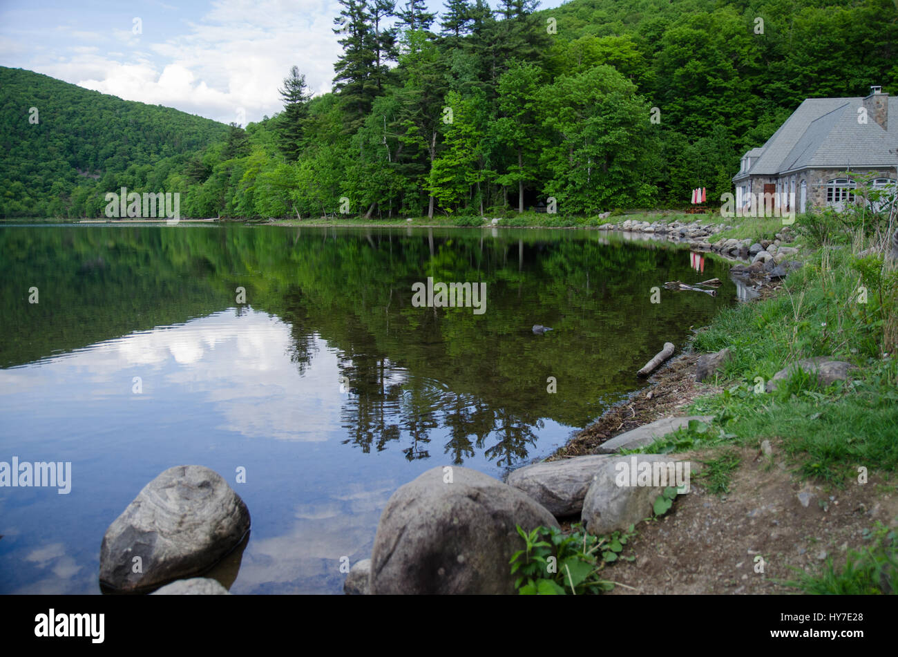 A beautiful lake and a chalet in a forest on mount Saint Hilaire Quebec ...