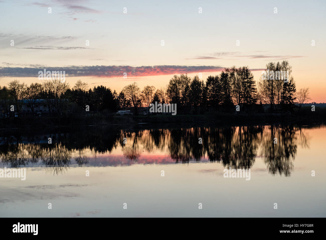 Beautiful dramatic sunset over the lake with clouds and reflections ...