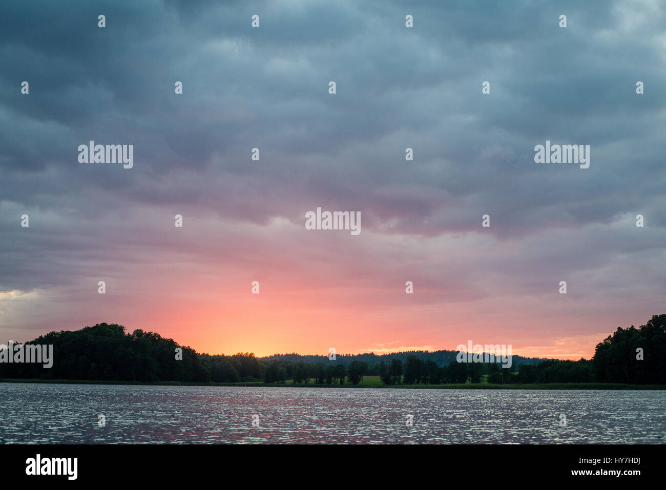 Dramatic summer sunset at the river with blue sky, red and orange ...