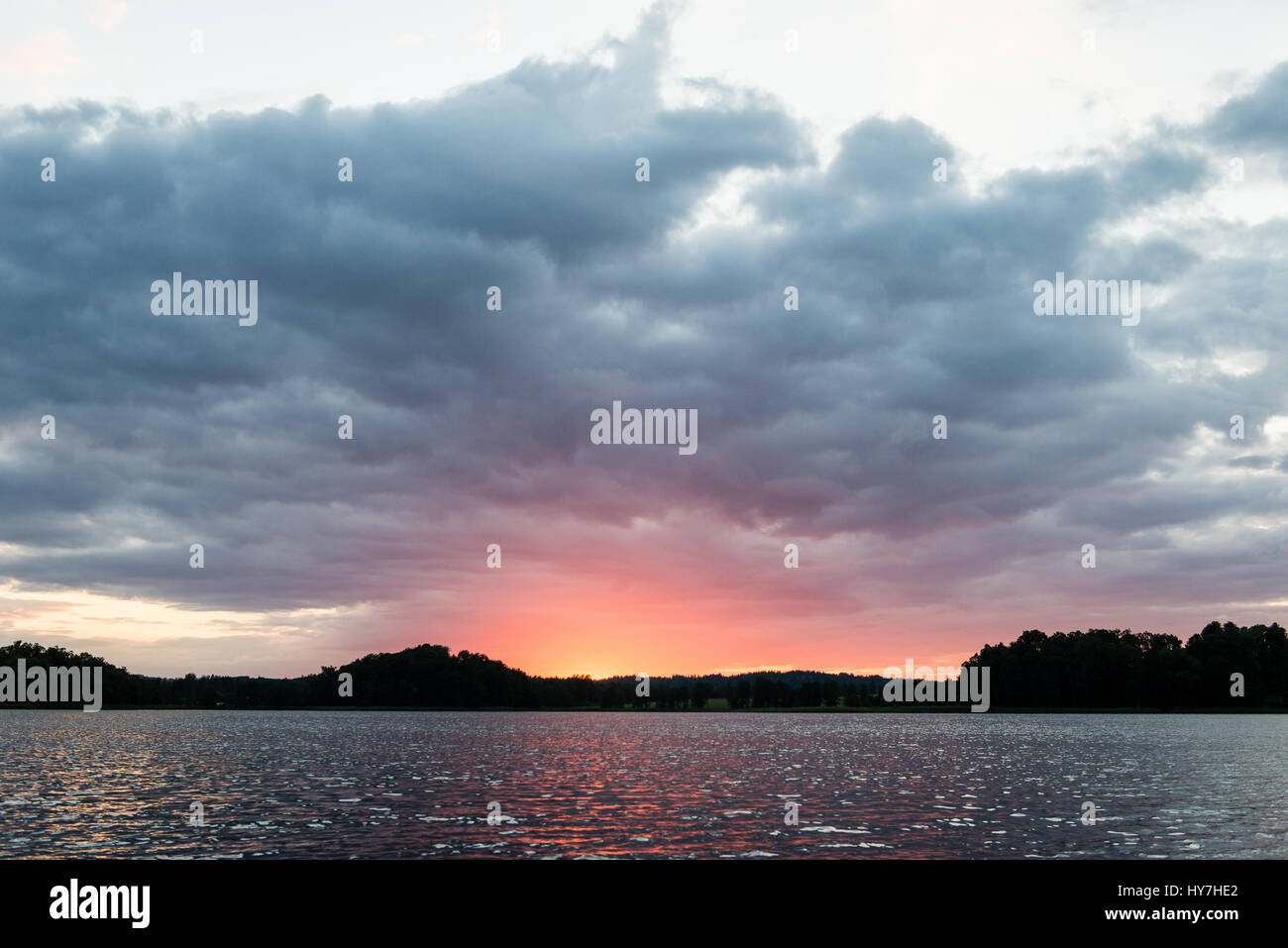Dramatic summer sunset at the river with blue sky, red and orange ...