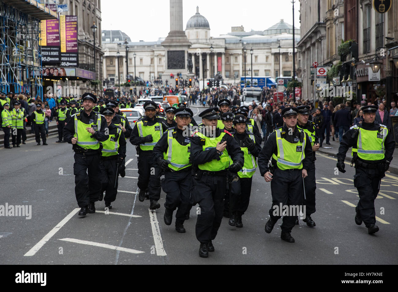 London, UK. 1st April, 2017. Police officers run down Whitehall towards ...