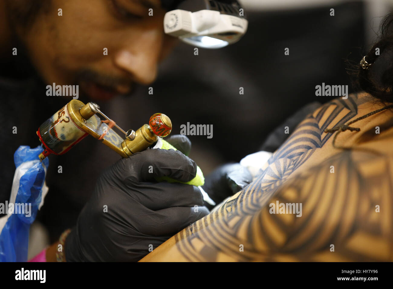 Lalitpur, Nepal. 2nd Apr, 2017. An artist makes a tattoo during the ...