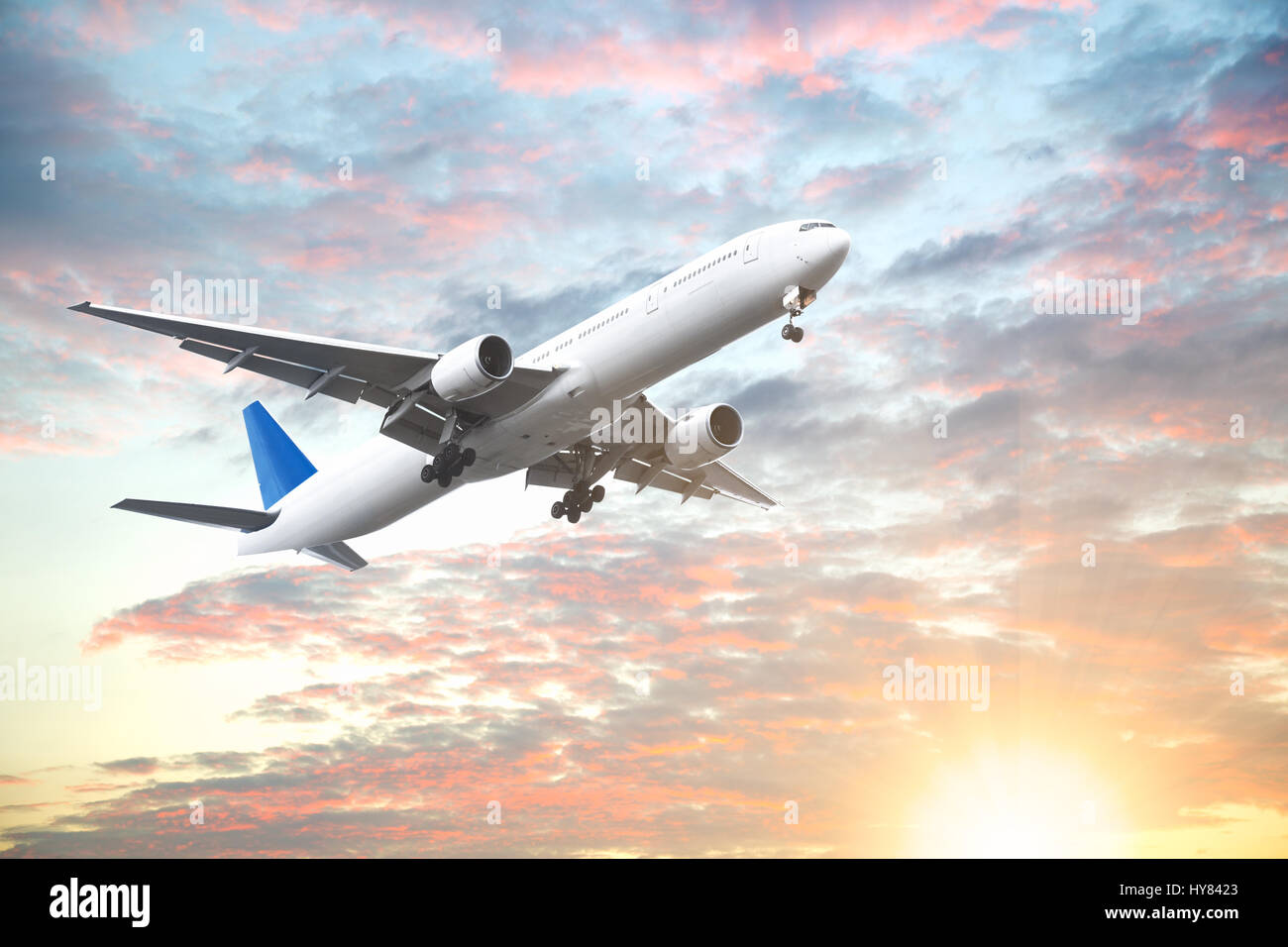 Airplane Flying In Sunset