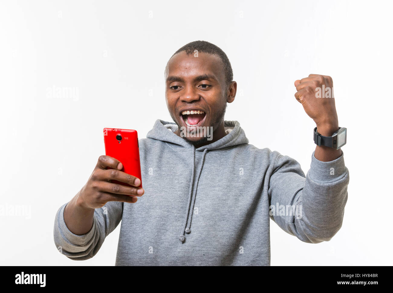 An African man uses a cellphone in a studio environment Stock Photo - Alamy