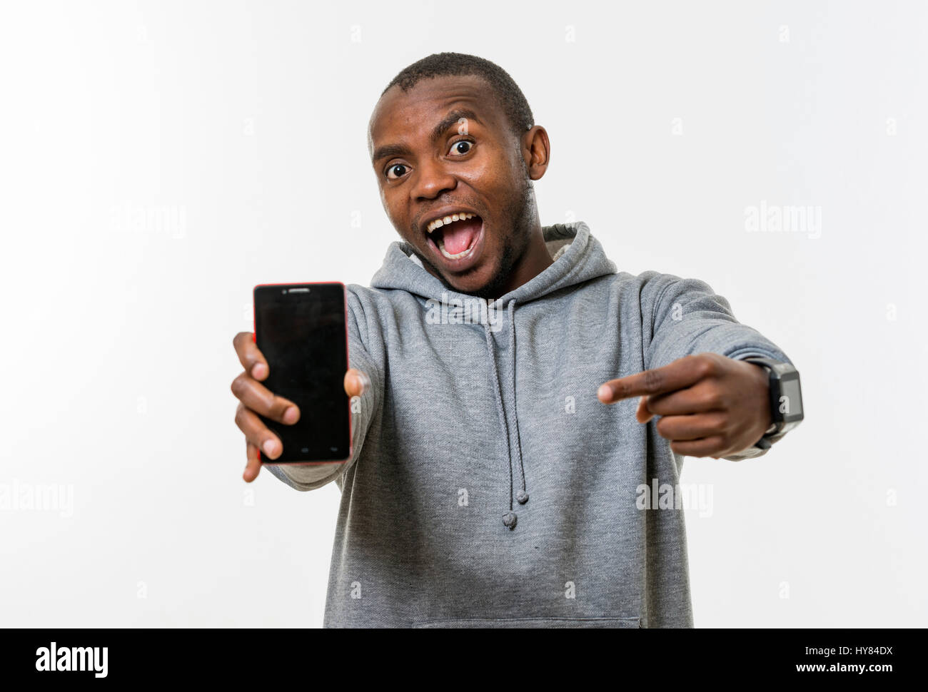 An African man uses a cellphone in a studio environment Stock Photo - Alamy