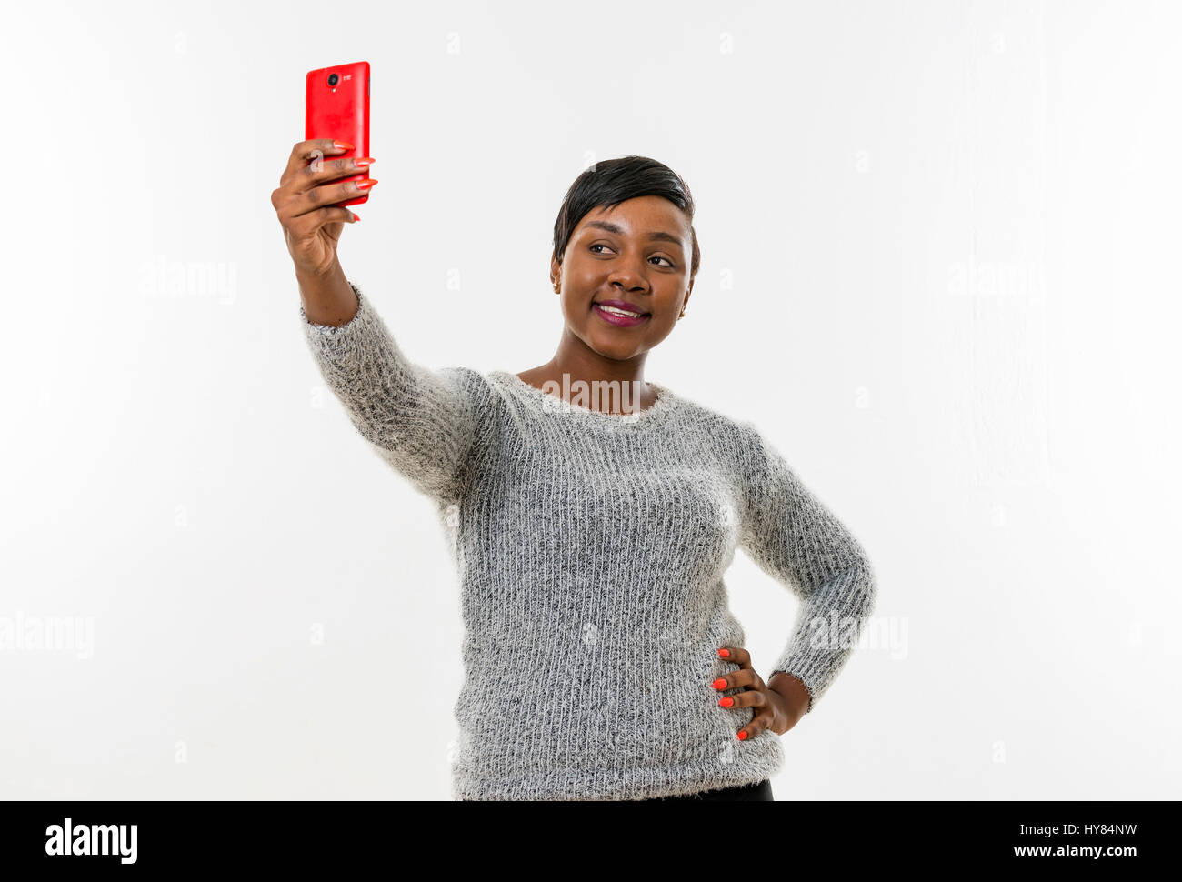 An African woman uses a cellphone in a studio environment Stock Photo ...