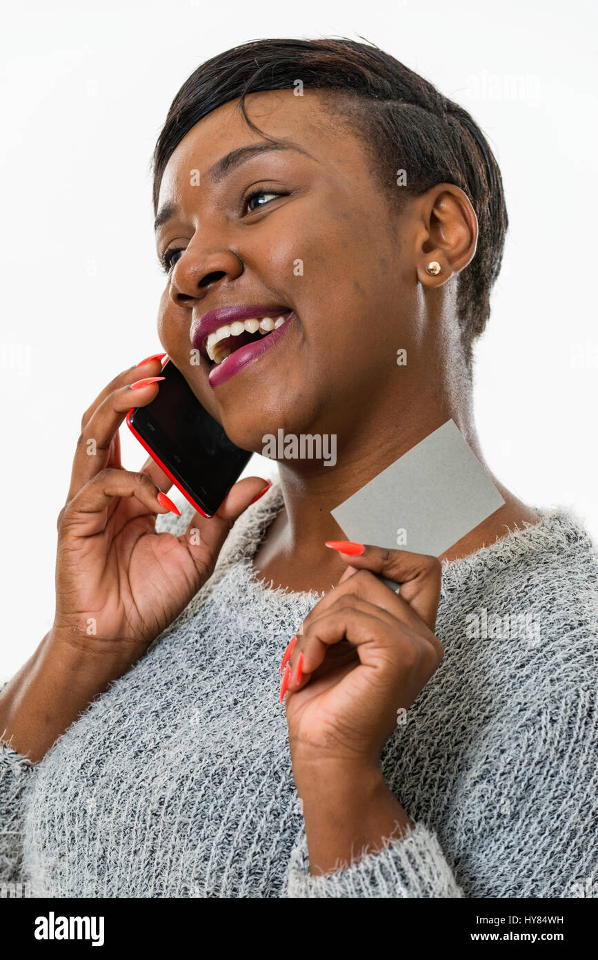 An African woman uses a cellphone in a studio environment Stock Photo ...