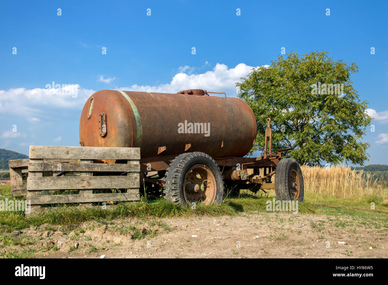 Old mobile cistern with water on the countryside. Abandoned old rusty ...