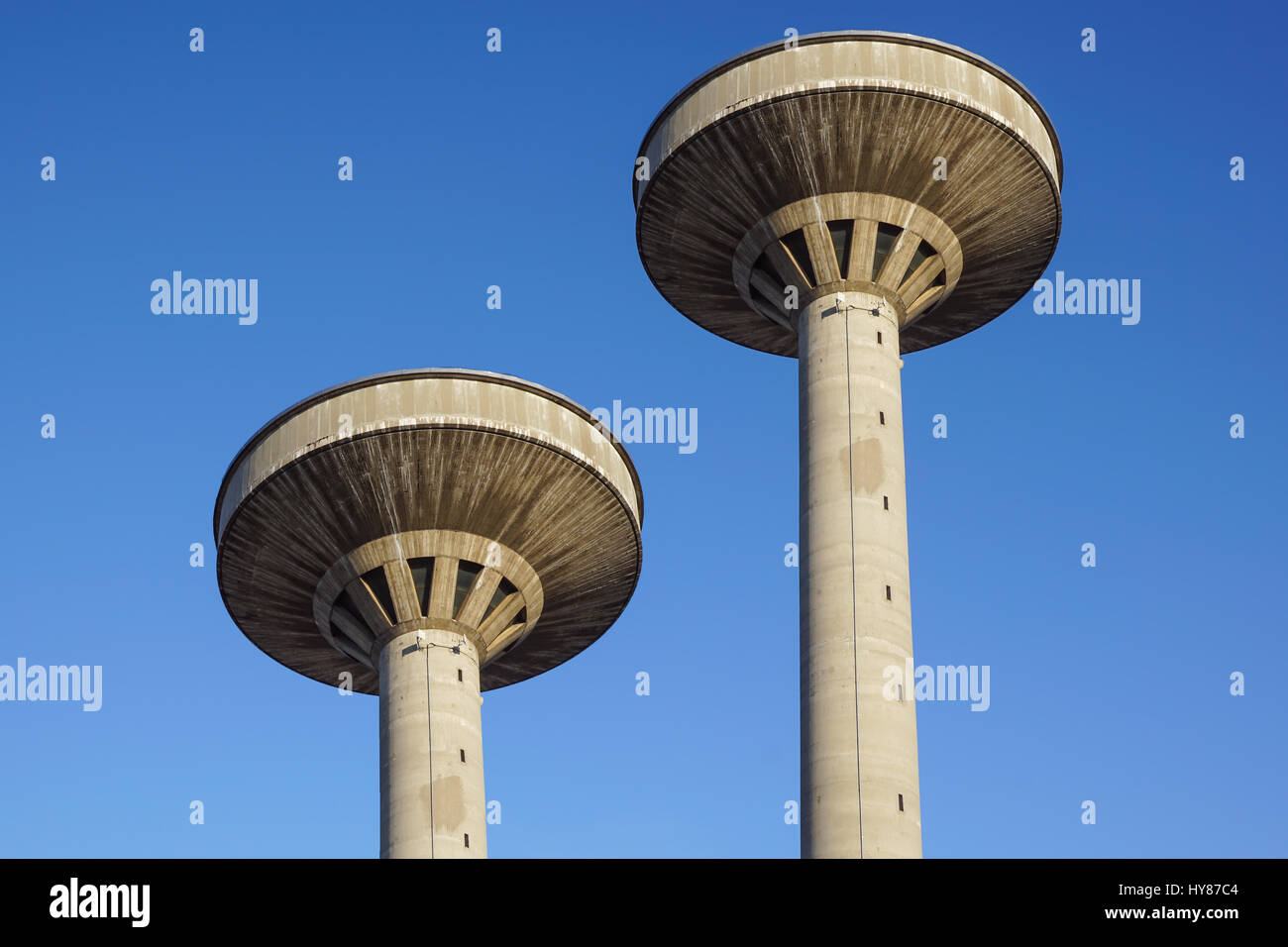 concrete two water towers against blue sky Stock Photo - Alamy