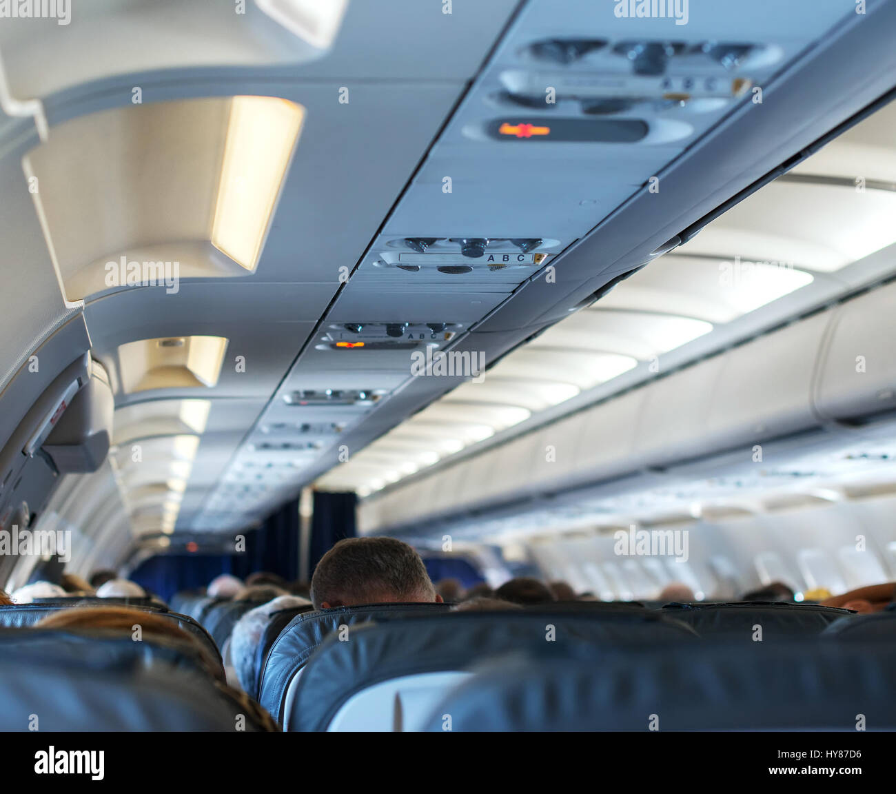 Interior inside of the plane with passengers Stock Photo - Alamy