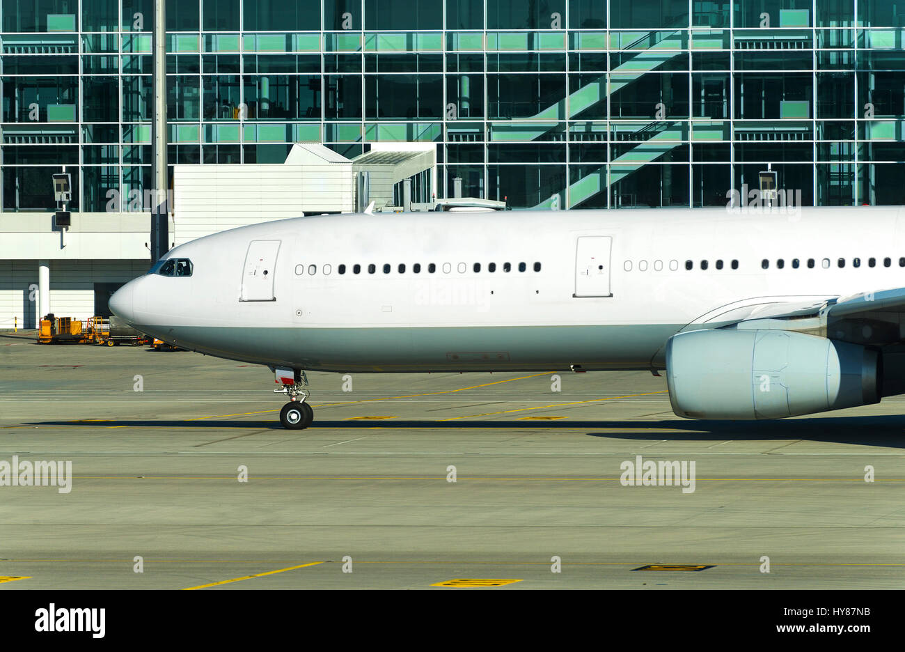 Side View of airplane on airfield in airport Stock Photo - Alamy