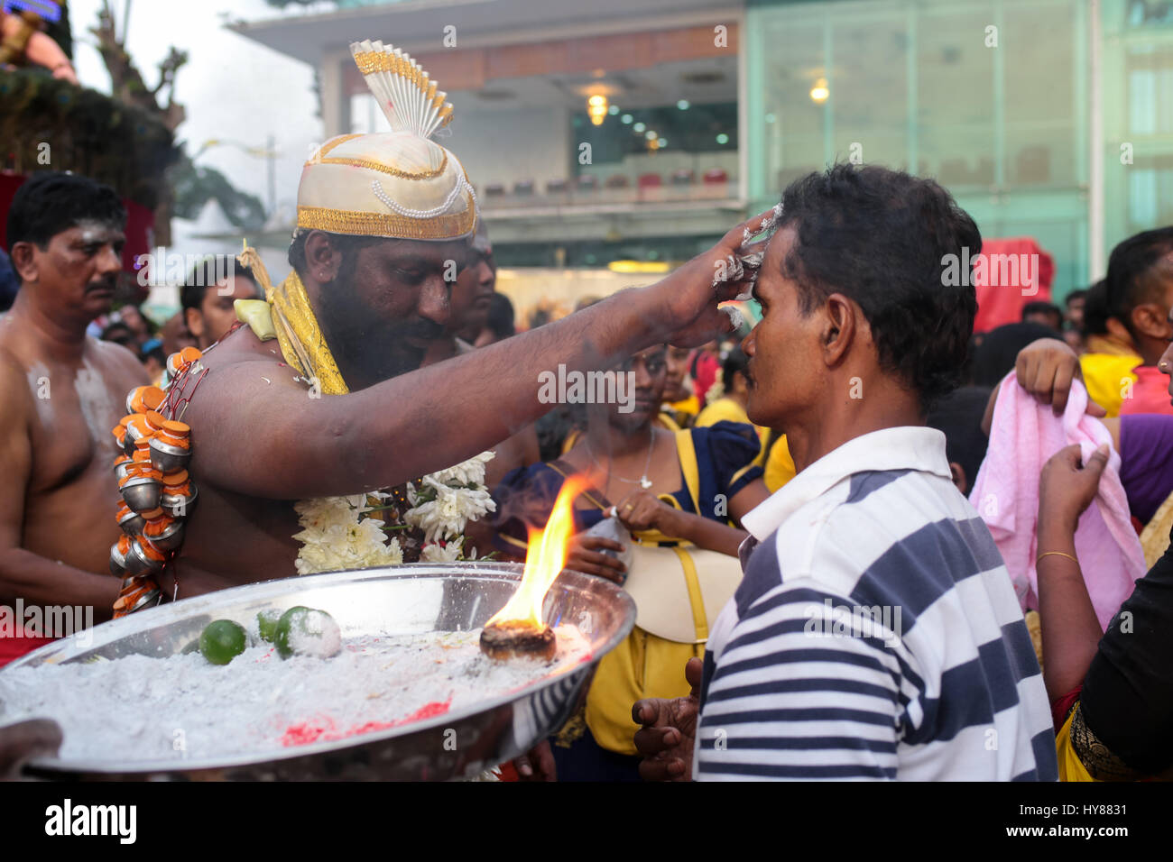 Kavadi bearer blessing a believer during Thaipusam at Batu Cave temple ...