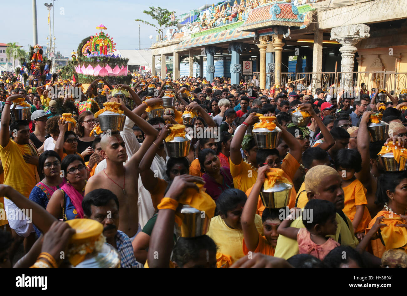 Crowd of Thaipusam paal kudam bearers and tourists at Batu Cave temple ...