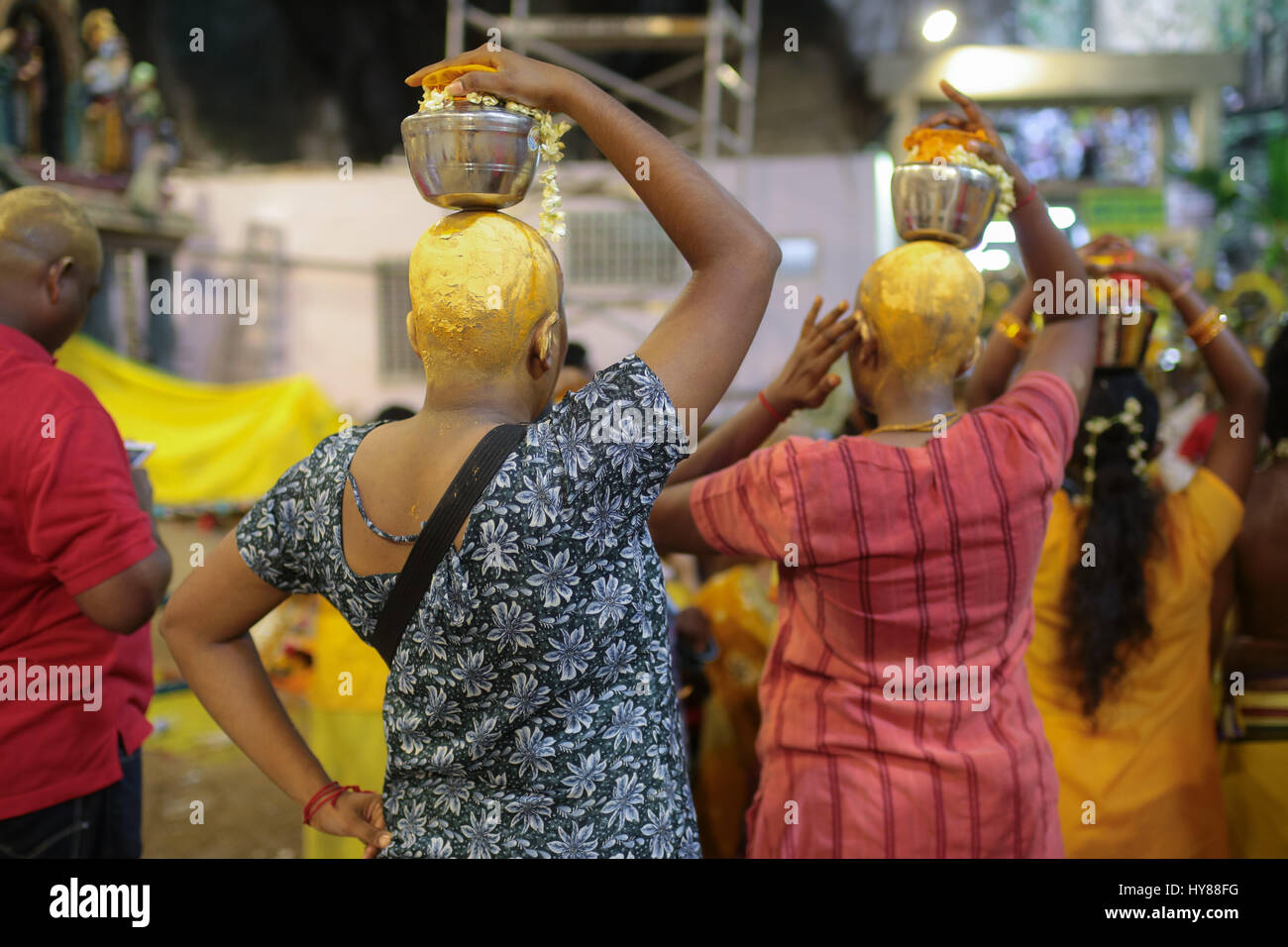 Female paal kudam bearers with shaved head at Batu Cave temple, Kuala ...