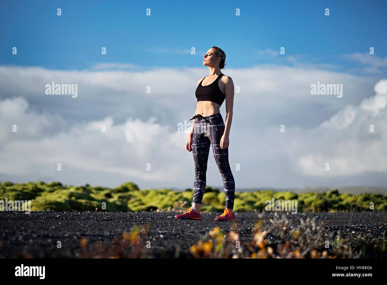 Young women resting looking up with her eyes closed after running in ...