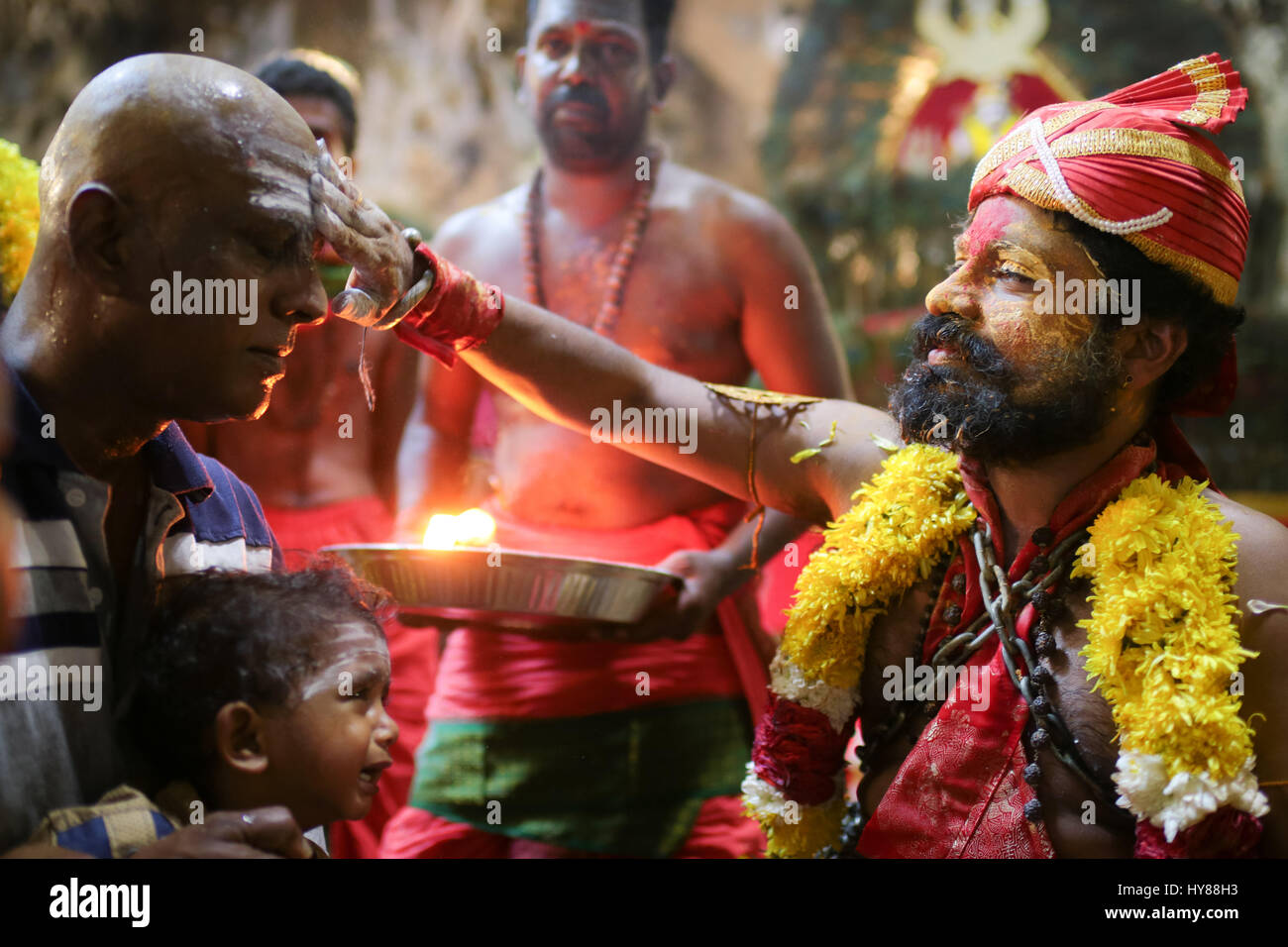 Thaipusam kavadi bearer bestows blessing to believer at Batu Cave ...