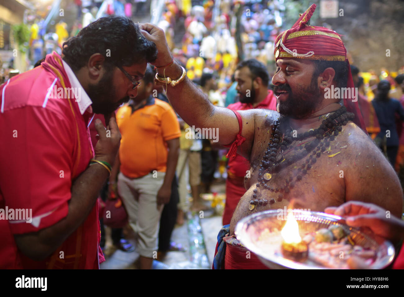 Thaipusam kavadi bearer bestows blessing to believer at Batu Cave ...