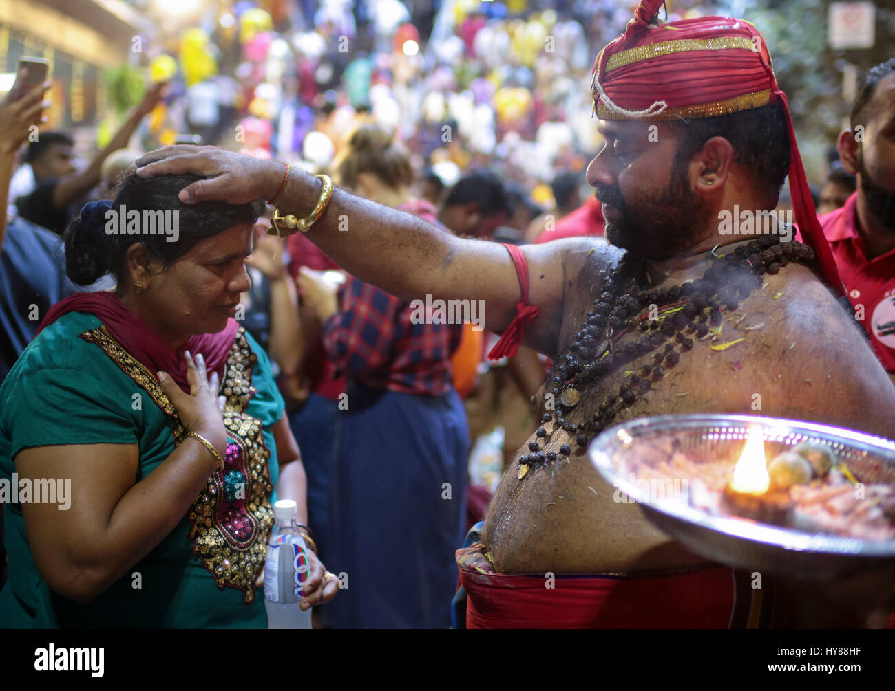 Thaipusam kavadi bearer bestows blessing to believer at Batu Cave ...