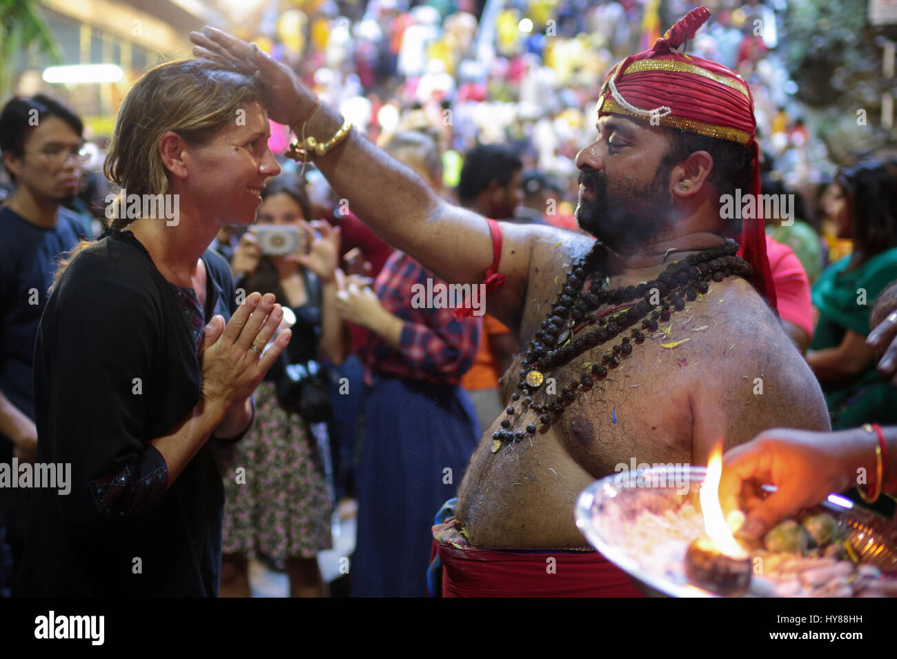 Thaipusam kavadi bearer bestows blessing to believer at Batu Cave ...