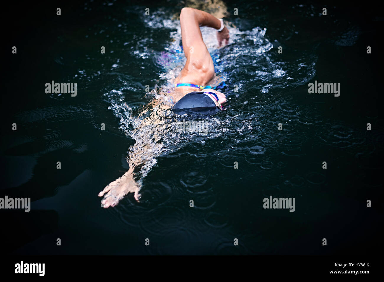 Happy confident young female swimmer in an outside pool in southern ...
