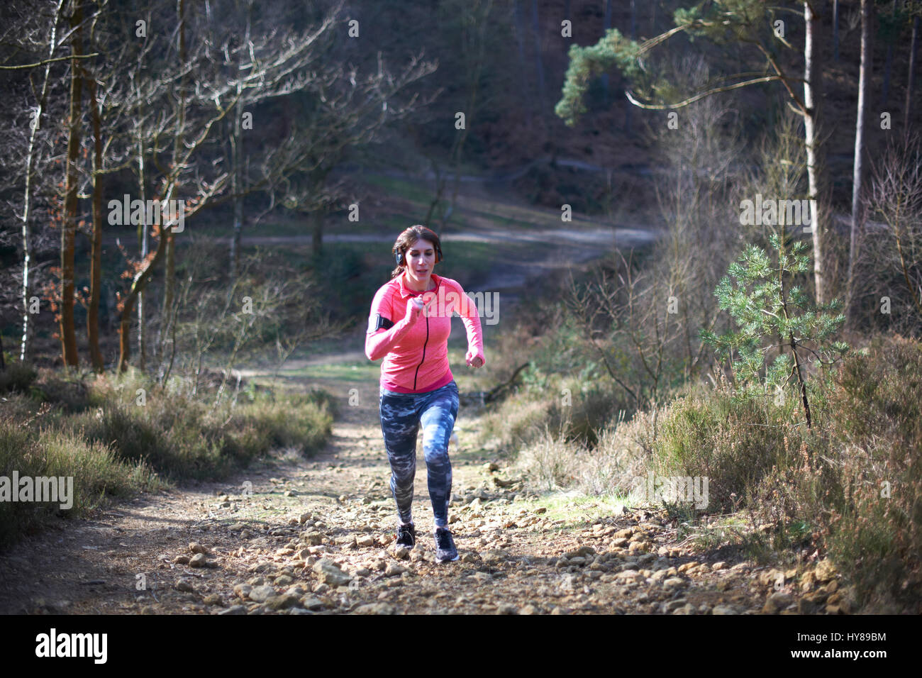 A woman running uphill Stock Photo - Alamy