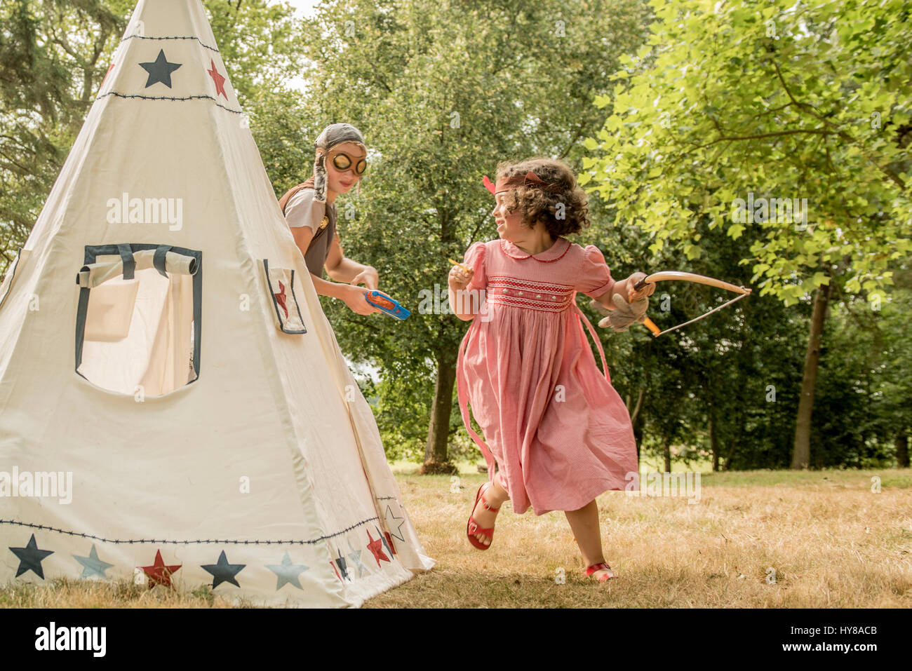 Young children play games outside in the sunshine Stock Photo - Alamy
