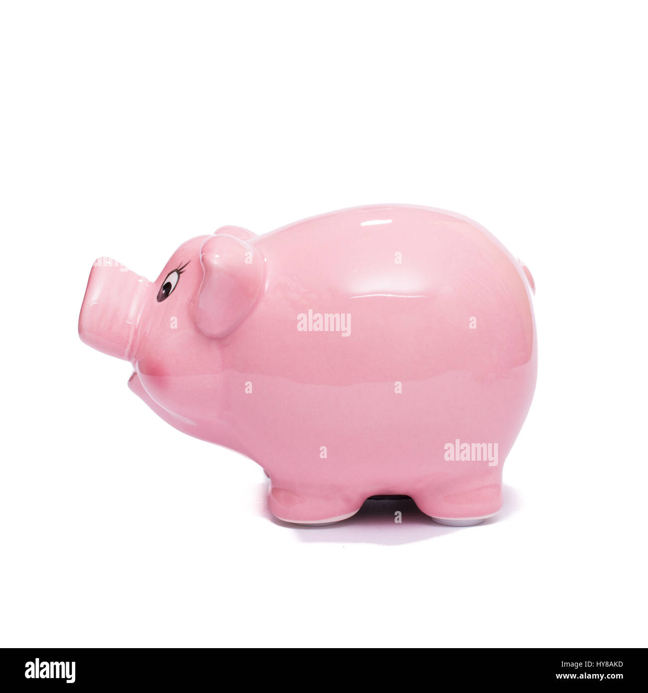 Pink piggy bank askance white isolated Stock Photo - Alamy