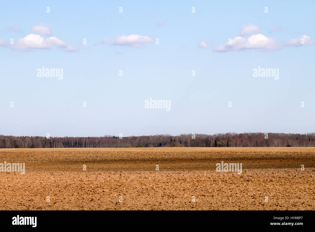 Landscape with plowed field in early spring Stock Photo - Alamy