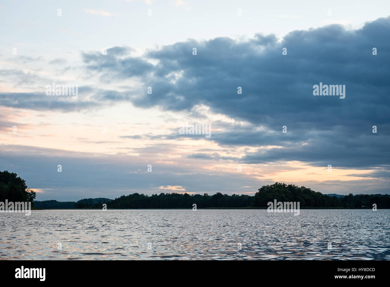Beautiful summer sunset at the river with blue sky, red and orange ...