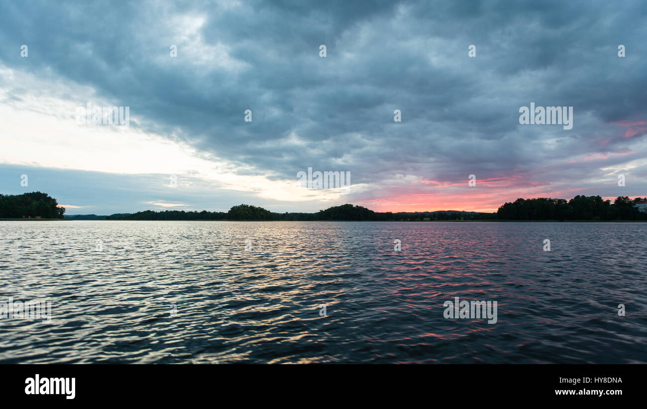 Dramatic summer sunset at the river with blue sky, red and orange ...