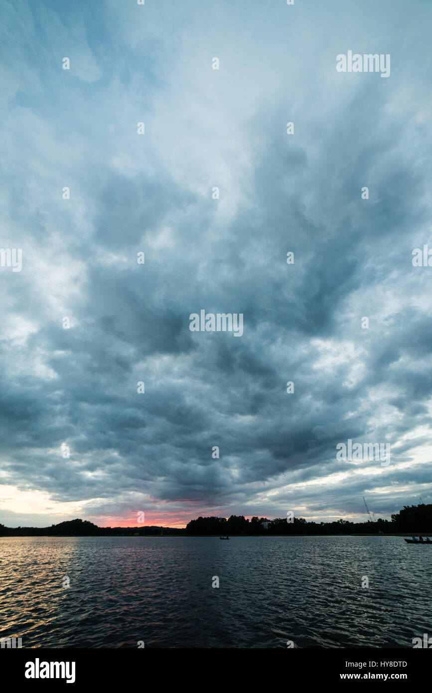 Dramatic summer sunset at the river with blue sky, red and orange ...
