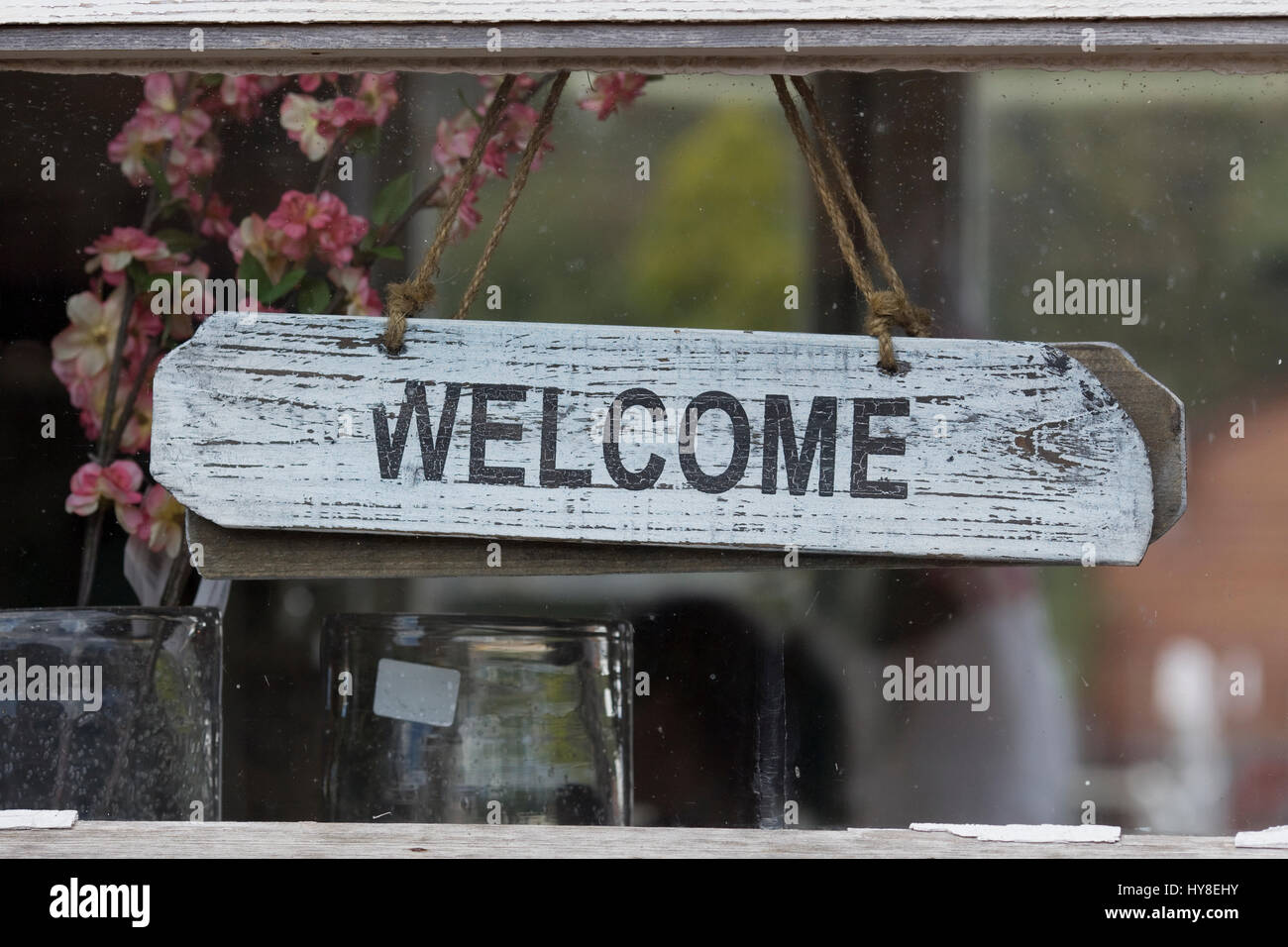 Wooden welcome sign on glass Stock Photo - Alamy