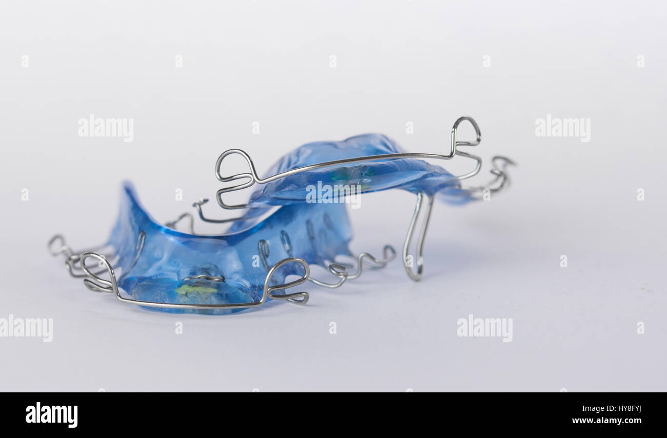 Close up photo of blue dental braces, isolated on a white background ...