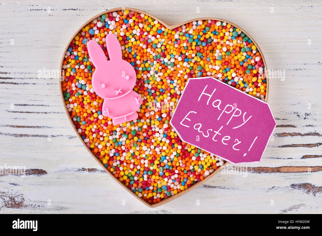 Sweets and Happy Easter card. Heart box on wooden background. Easter ...
