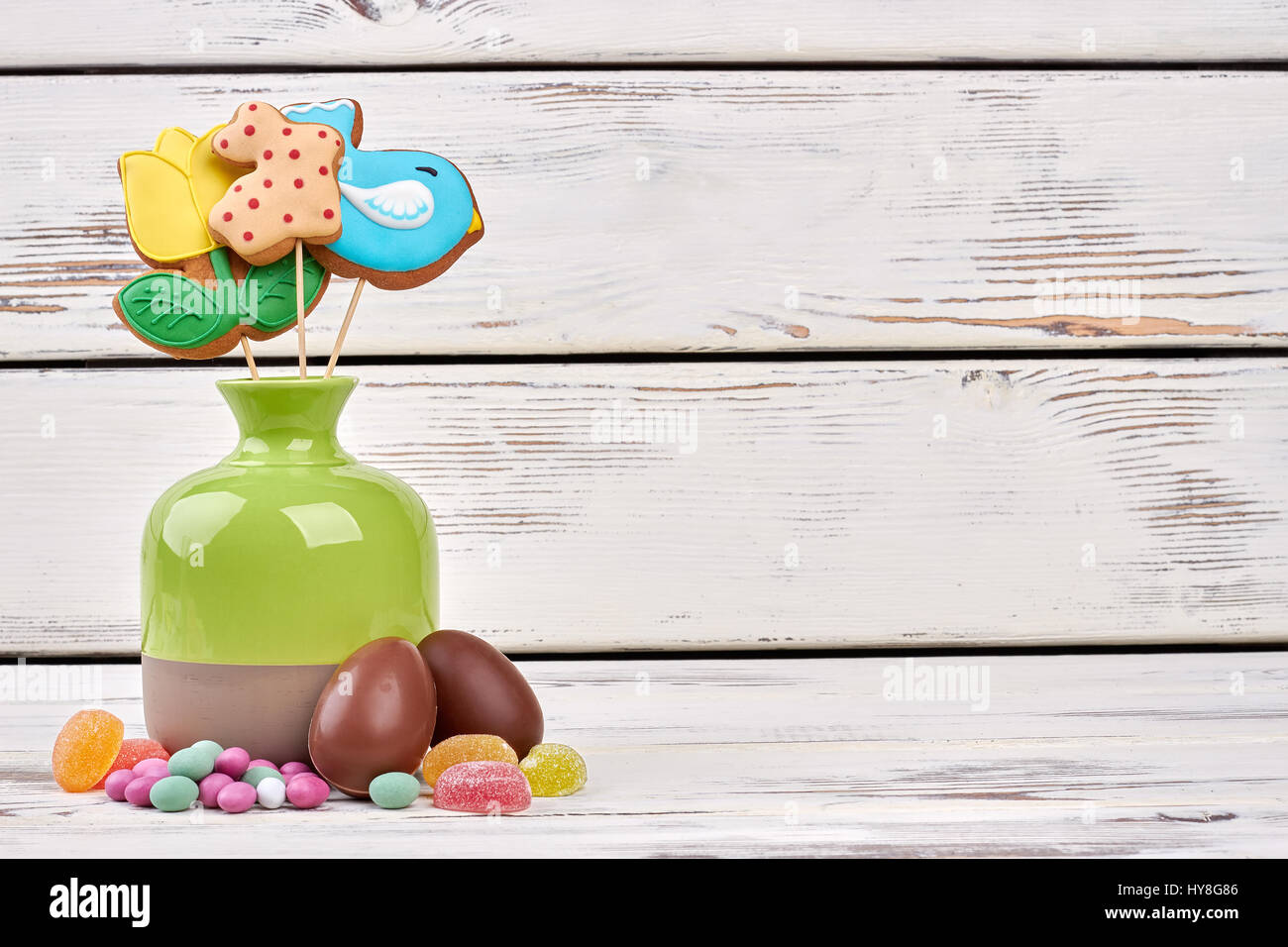 Easter themed sweets and vase. Cookies on sticks, chocolate eggs Stock ...