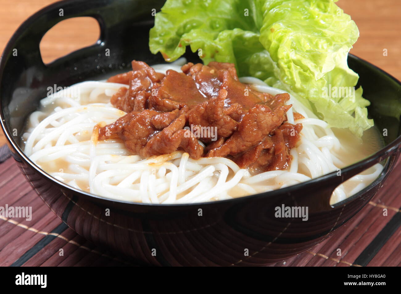 a cuisine photo of noodles with meat Stock Photo - Alamy