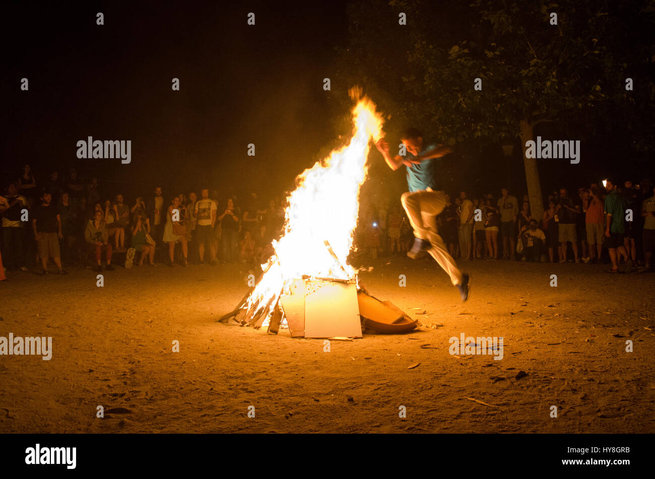 A man jumping a bonfire during Saint John's Eve in Madrid Stock Photo ...
