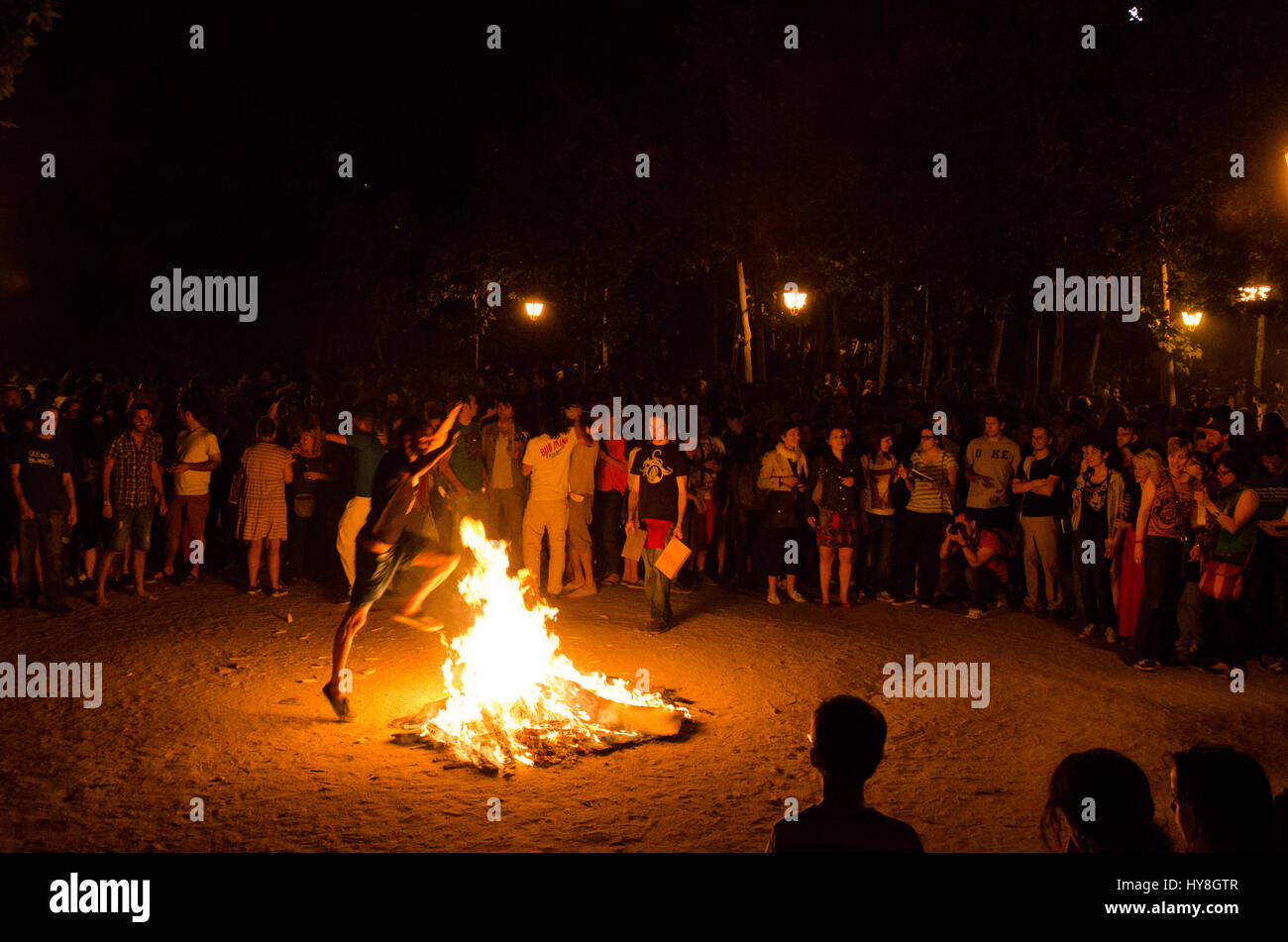 A man jumping through the fire of a bonfire during Saint John's Eve in ...