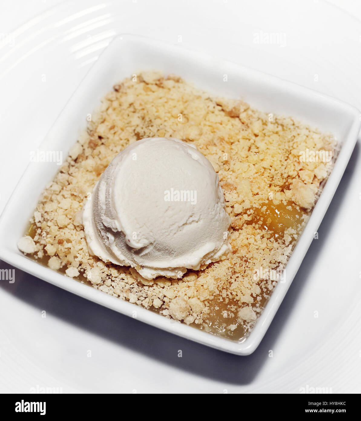 Apple crumble dessert with vanilla ice cream Stock Photo - Alamy