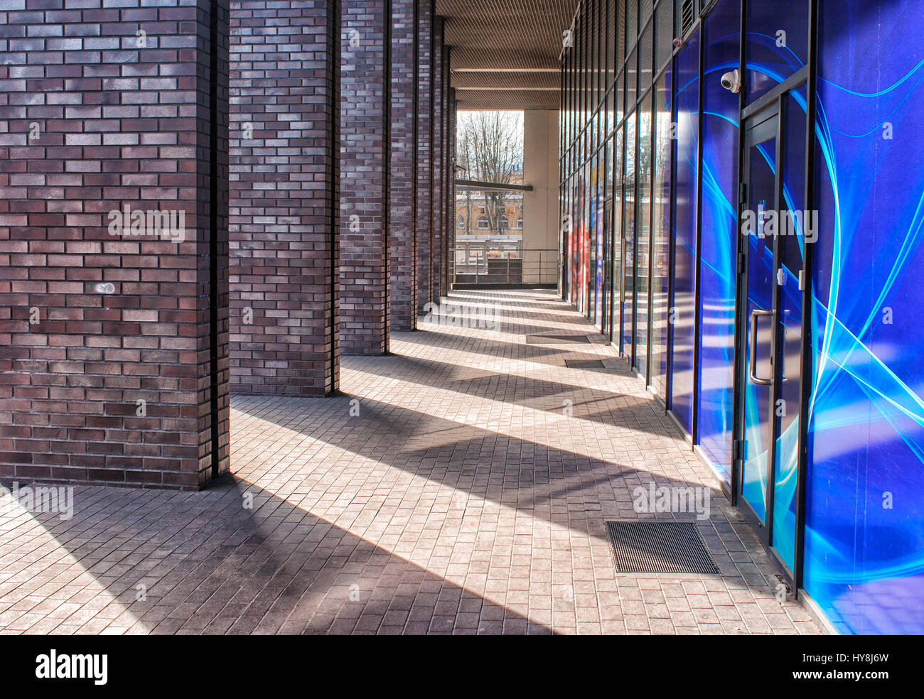 corridor of brick columns in a modern building outdoor on sunny day ...