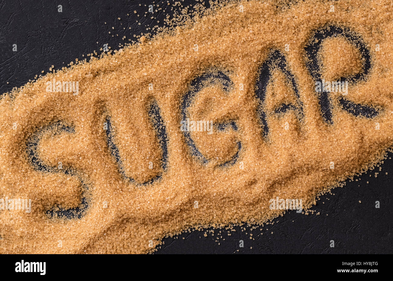 Brown sugar word on dark background Stock Photo - Alamy