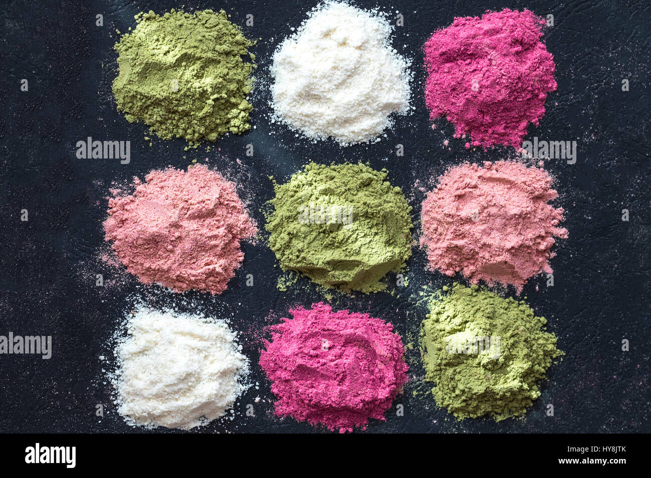 Various colorful superfood powders on dark background. Healthy food ...
